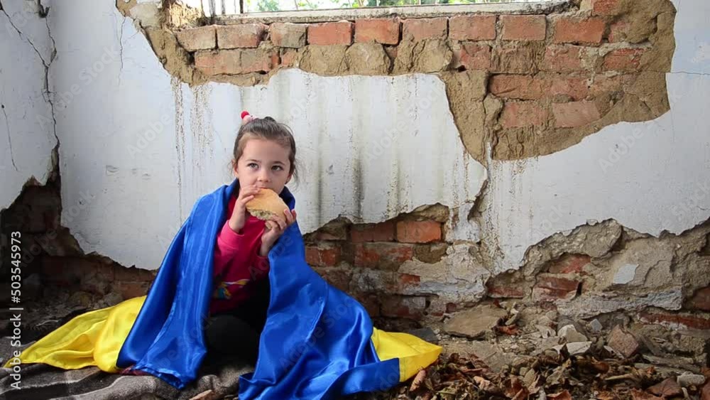 humanitarian catastrophe. The child eats in the ruins because of the ...