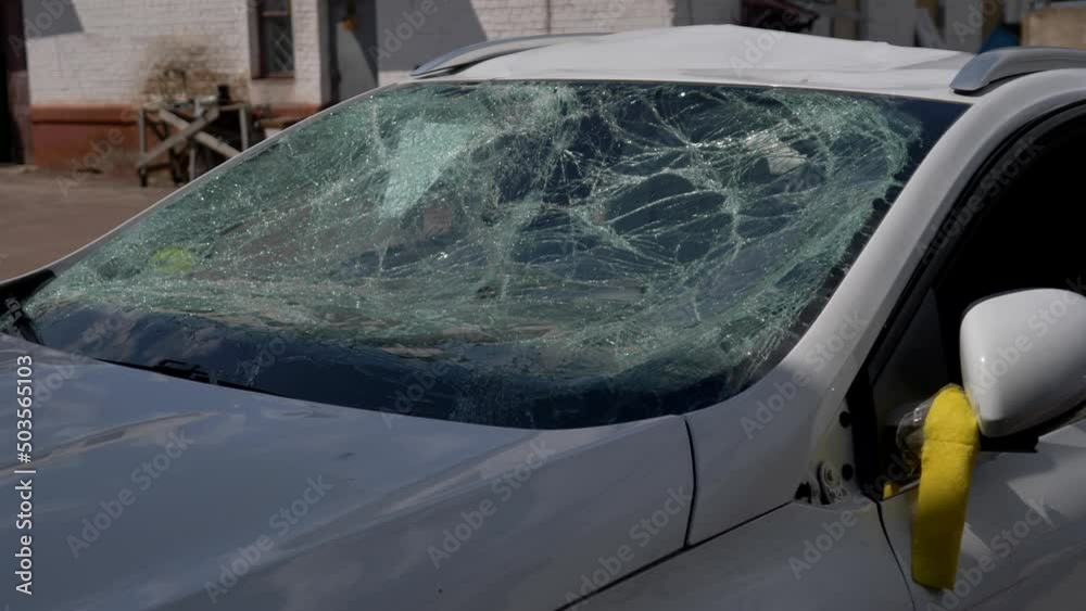 Close-up of a broken windshield in a car after being hit by a ...