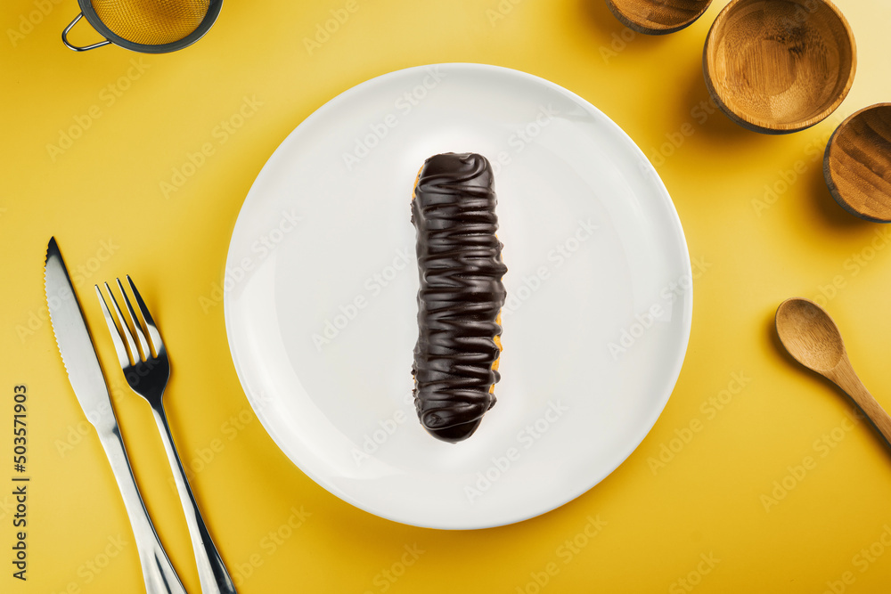 Dessert Bomba de Chocolate. Brazilian traditional éclair in white plate ...