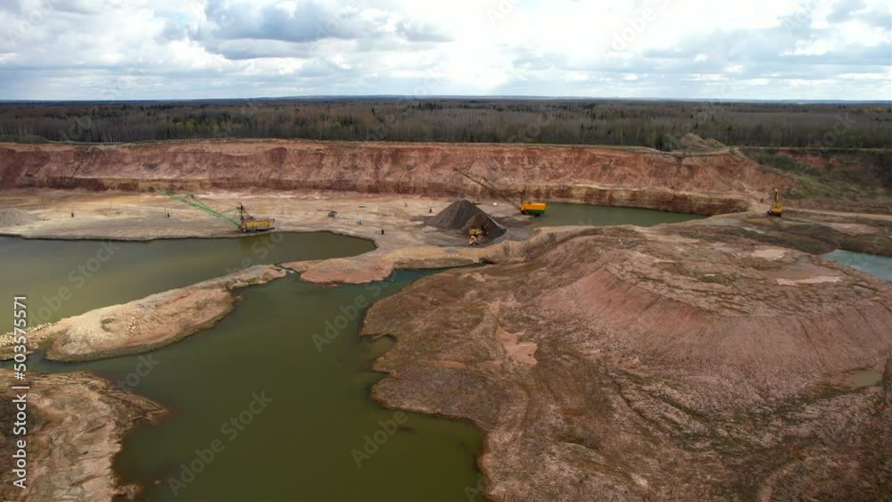 Mining excavator loading dolomite minerals in haul truck. Limestone ...