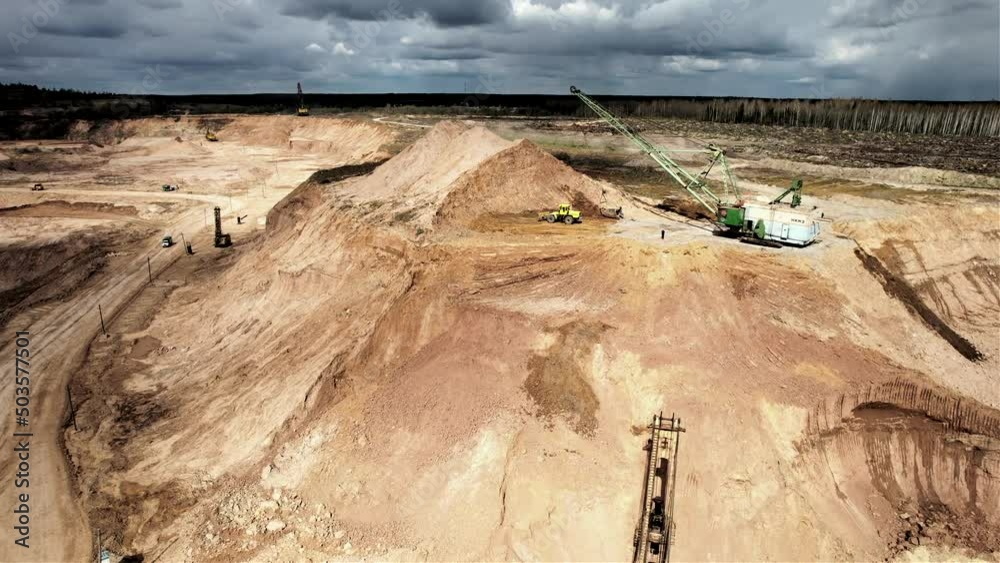 Mining excavator loading dolomite minerals in haul truck. Limestone ...