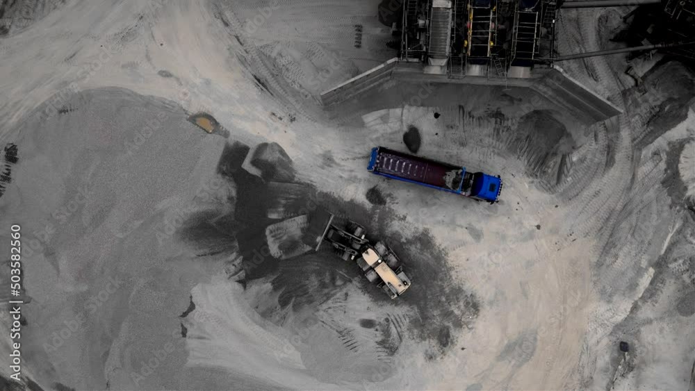 Wheel loader load gravel and crushed stones in dump truck. Front end ...