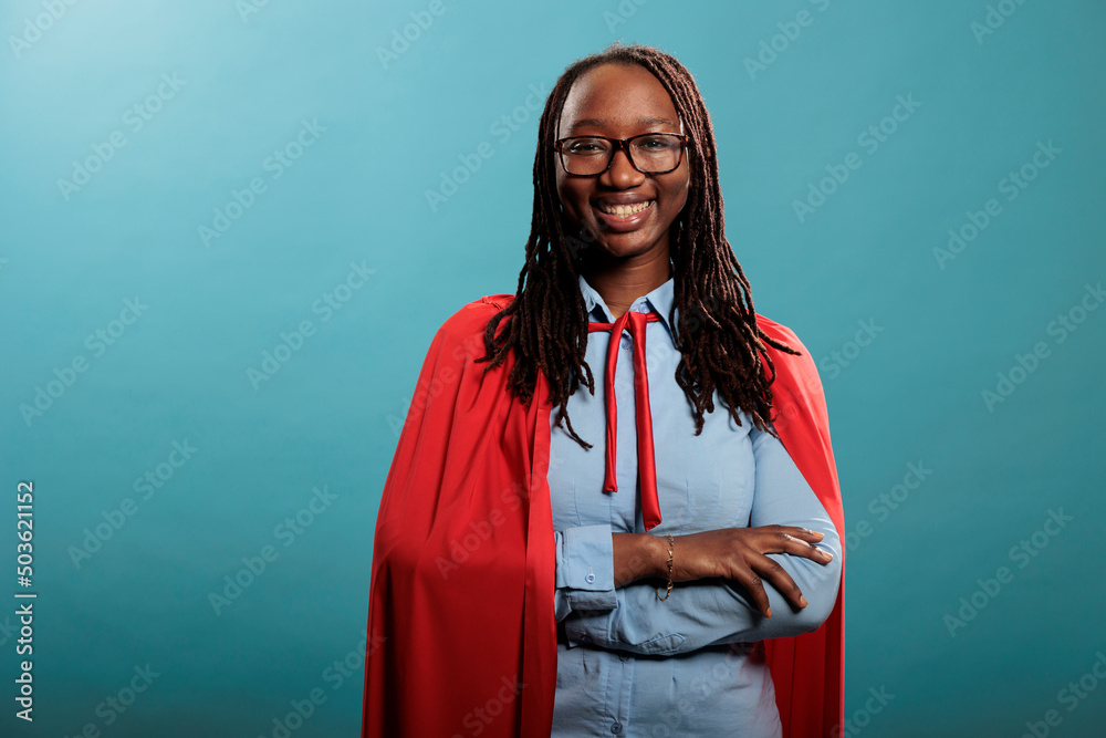 Happy joyful smiling superhero woman wearing hero mighty cape while ...