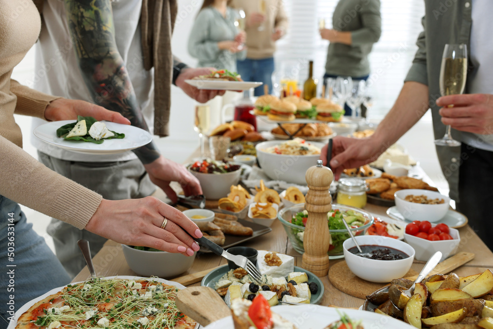 People near buffet table with food indoors, closeup. Brunch setting ...