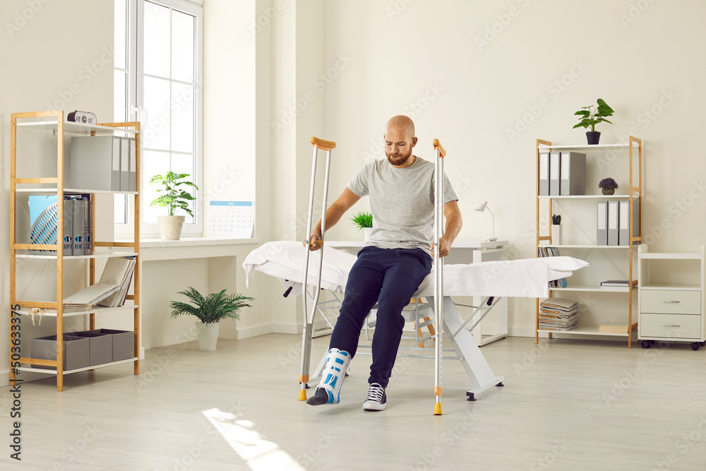 Young guy undergoing rehabilitation after foot injury. Male patient ...