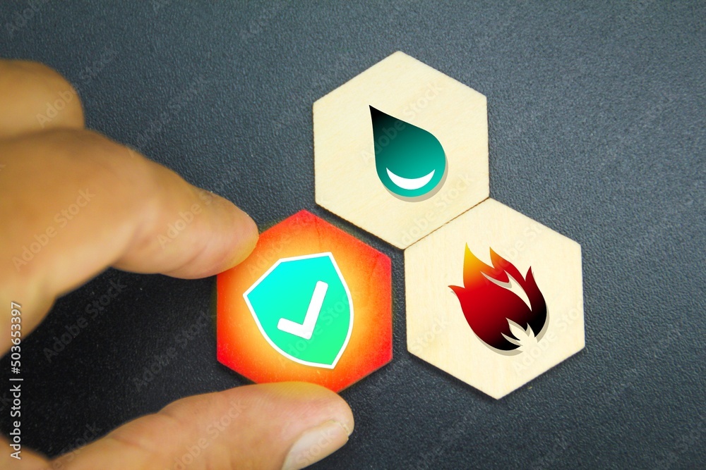 hand holding a hexagon with icons of water and fire and safety. the ...