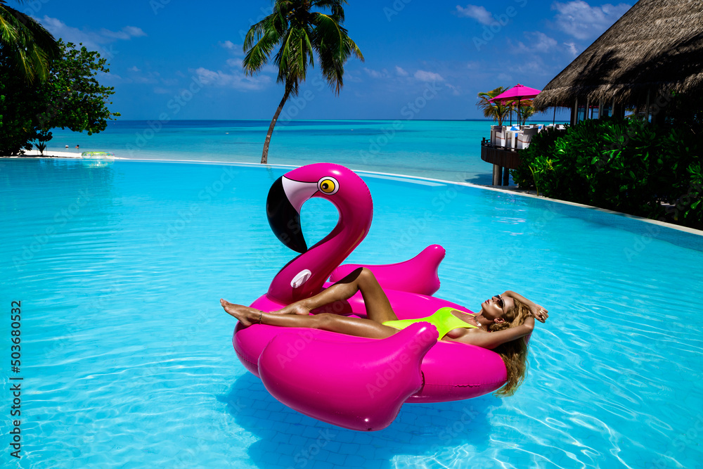Beautiful Sexy Tanned Woman On Pink Flamingo In Pool Young Glamour