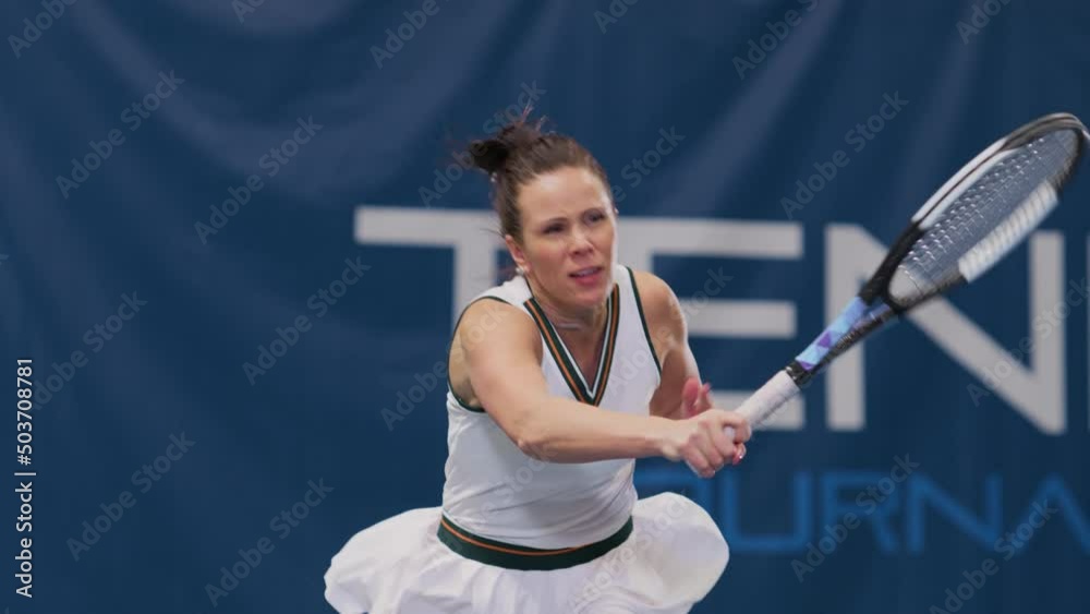 Female Tennis Player Hitting Ball with Racquet on Championship Match ...