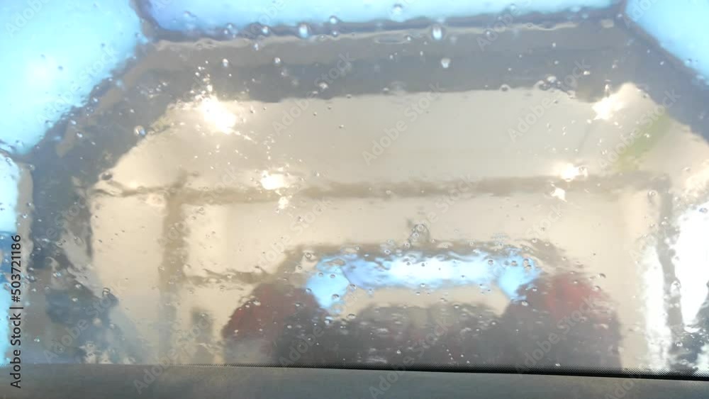Washing the car in an automatic car wash, view of the inside of the car ...
