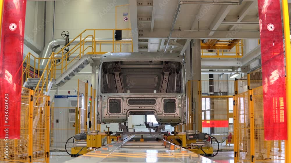 Metal frame of car at factory. Scene. Body frame for truck is assembled ...