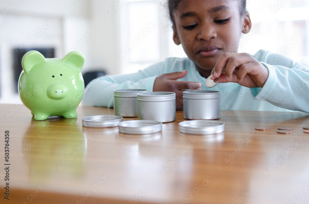 young girl learning money concepts Stock Photo | Adobe Stock