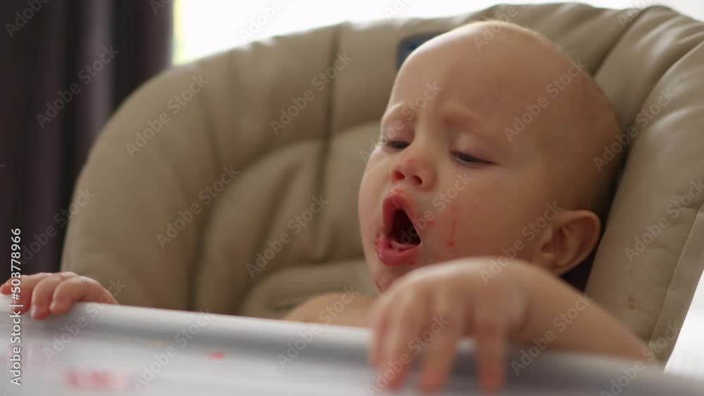 choke on baby child sitting feeding chair indoors, trying spit out food ...