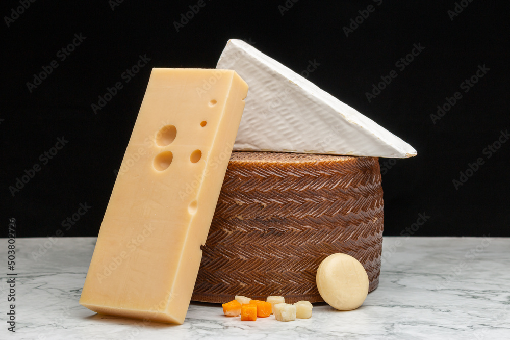 Closeup image of a white Akawi, Cheddar and Queso Blanco cheese and a ...