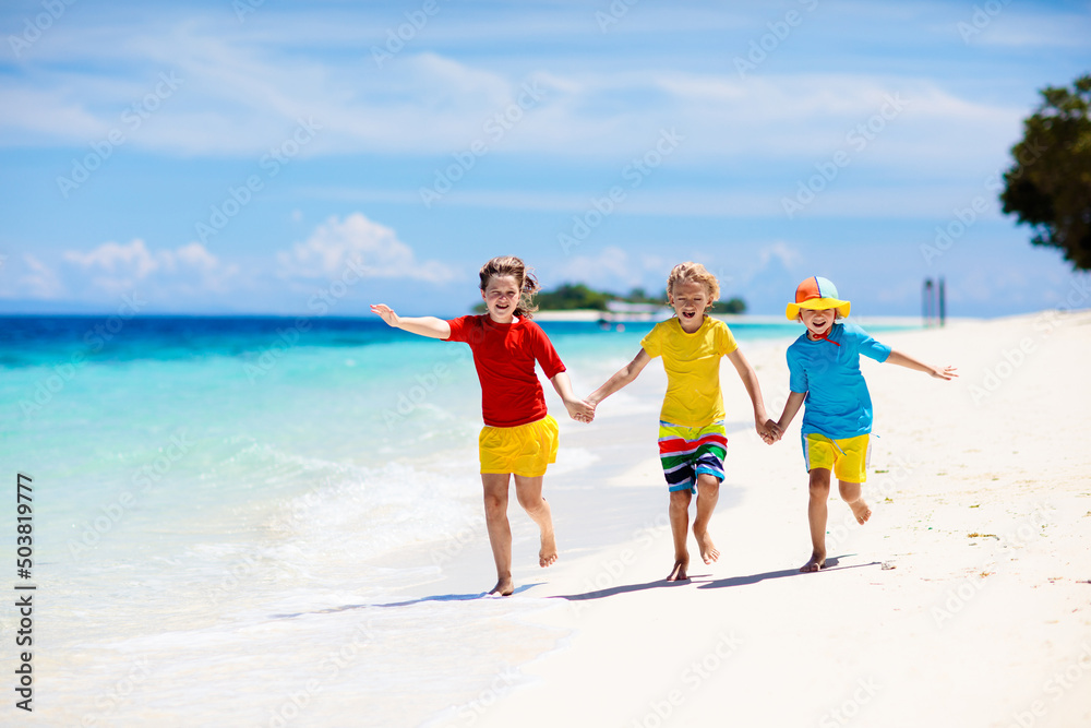 Kids playing on beach. Children play at sea. Stock Photo | Adobe Stock