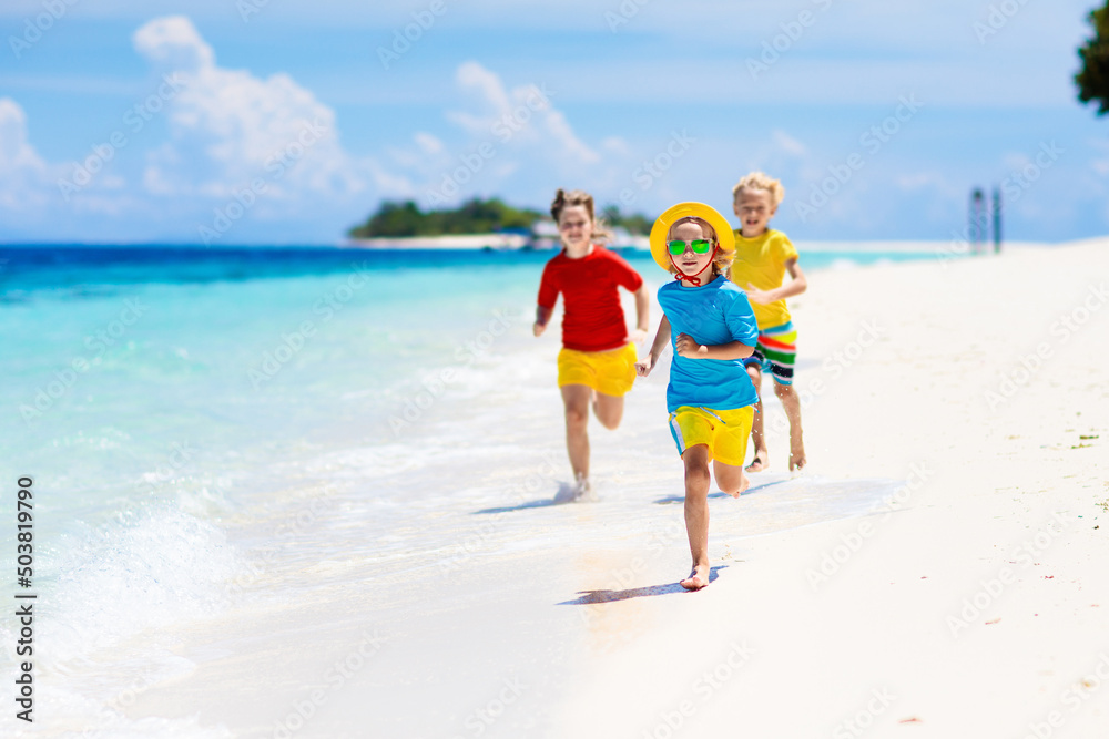 Kids playing on beach. Children play at sea. Stock Photo | Adobe Stock