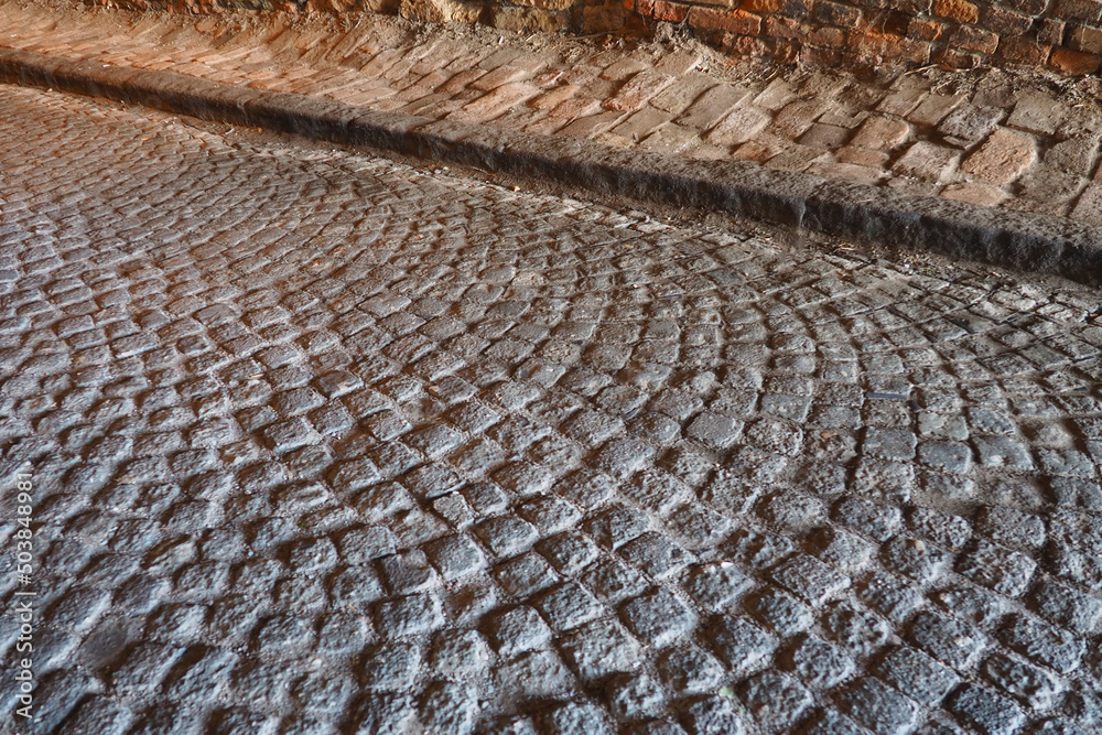 Paving stones - a hard road surface, a kind of pavement, lined with ...