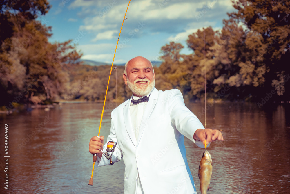 Fisherman caught a trout fish. Portrait of cheerful smiling angler ...