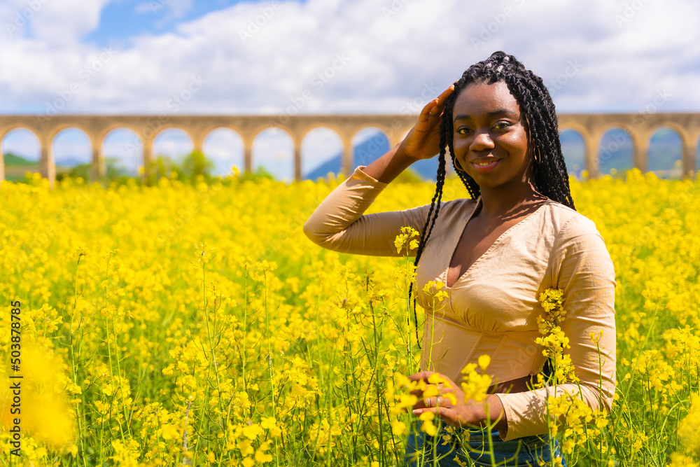 Lifestyle, portrait of a black ethnic girl with braids looking at ...