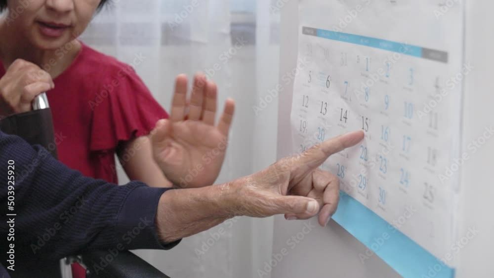 Read a calendar therapy exercises used by dementia patients Stock Video ...
