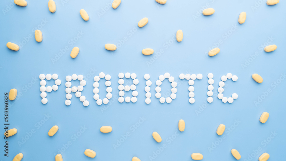 Probiotic supplement pills on blue background. Probiotic contains good ...