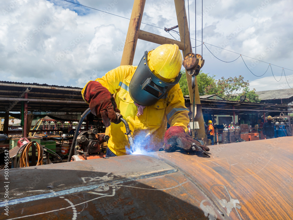 Welder is welding added joint a pipe carbon for steel structure work ...