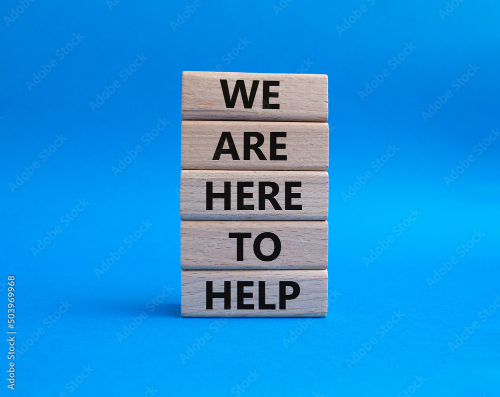 We are here to help symbol. Concept words we are here to help on wooden ...
