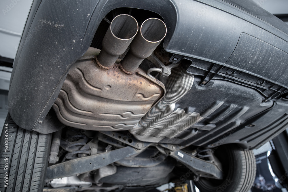 Poster Print Close up detail bottom view of car part metal exhaust muffler pipe with rusty stains 40x26.7 cm