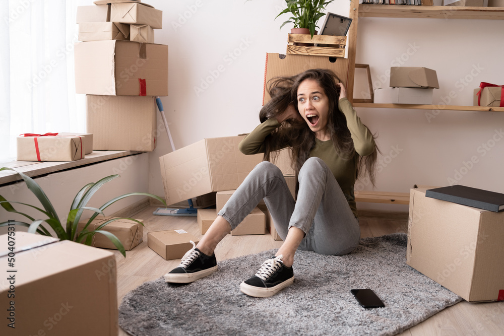 young woman moves to a new house, girl sits in a new apartment and ...