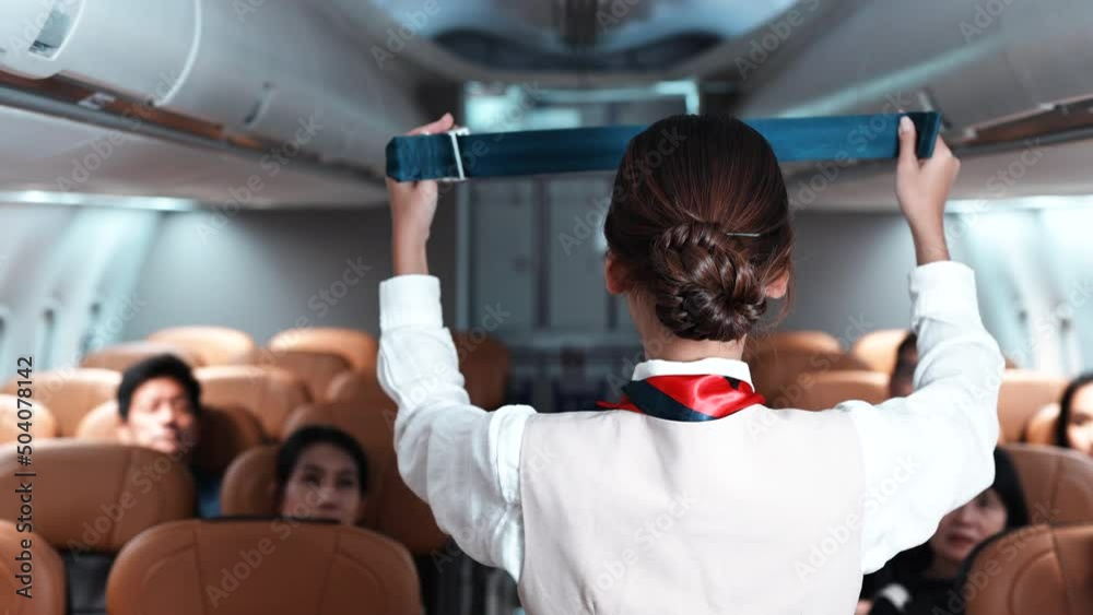 Asian beautiful female flight attendants explaining passengers how to ...