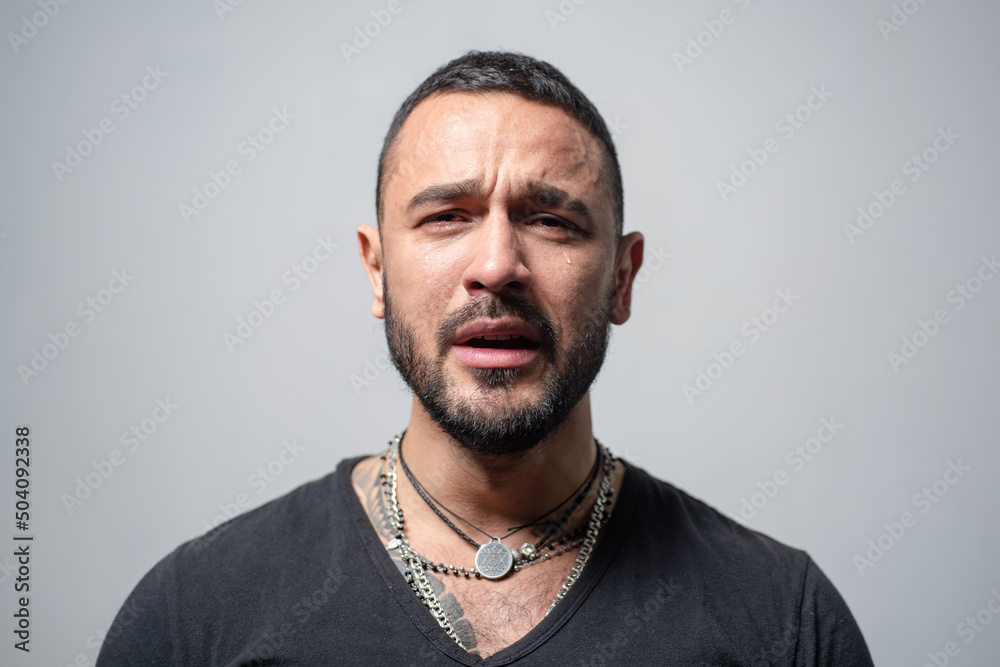 Sad face of young guy. Man cry with tears. Closeup portrait of a crying ...