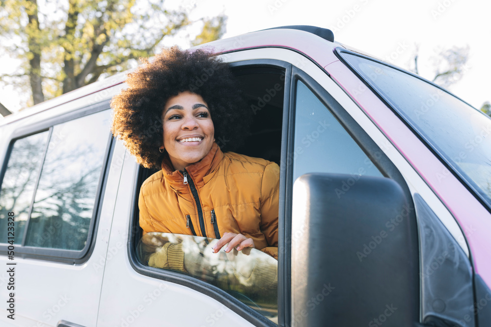 African American adult tourist woman opening the window of the ...