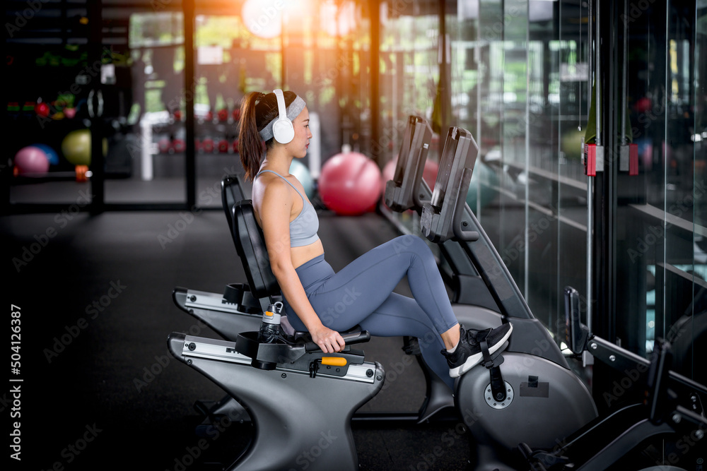 Fitness woman wearing sportwear and workout headband on in the gym ...