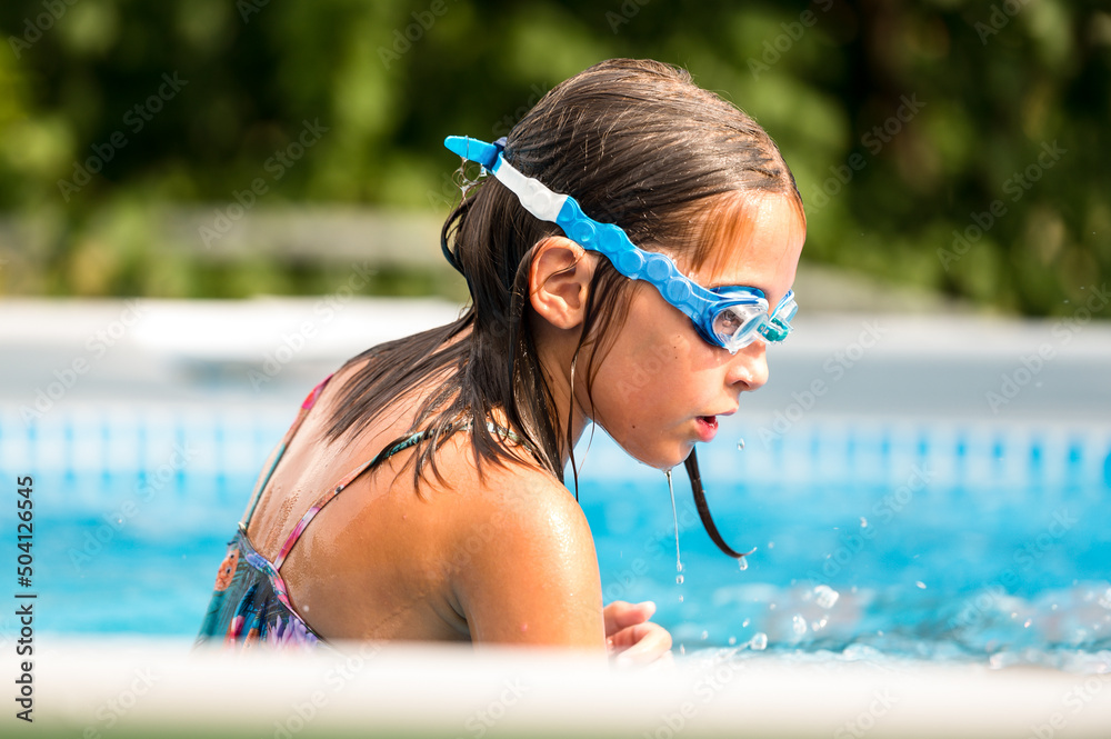 Foto de Children playing in home swimming pool in the summer. Girls are ...