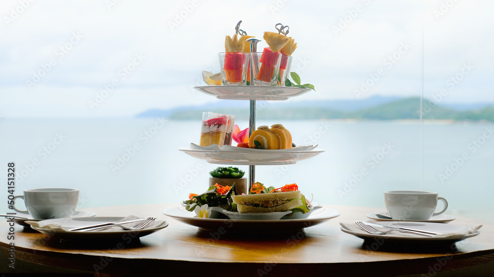 Traditional english high tea stand with selection of sweets, cakes ...