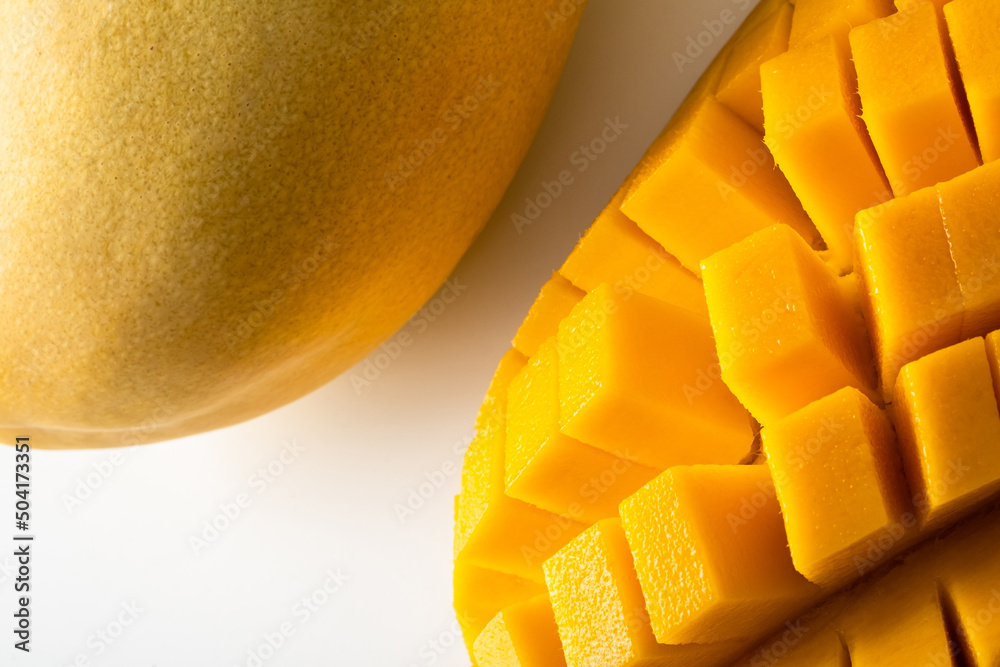 Juicy ripe yellow Thai mango on a white background. Hard light and ...