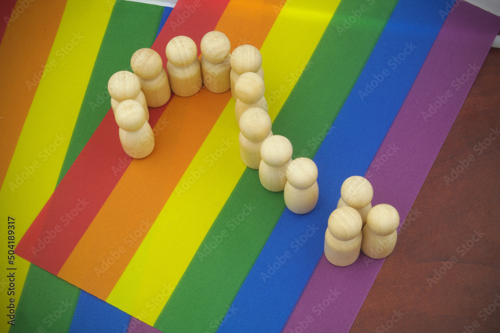 LGBT community FAQ concept. Wooden people figures shaped as question ...