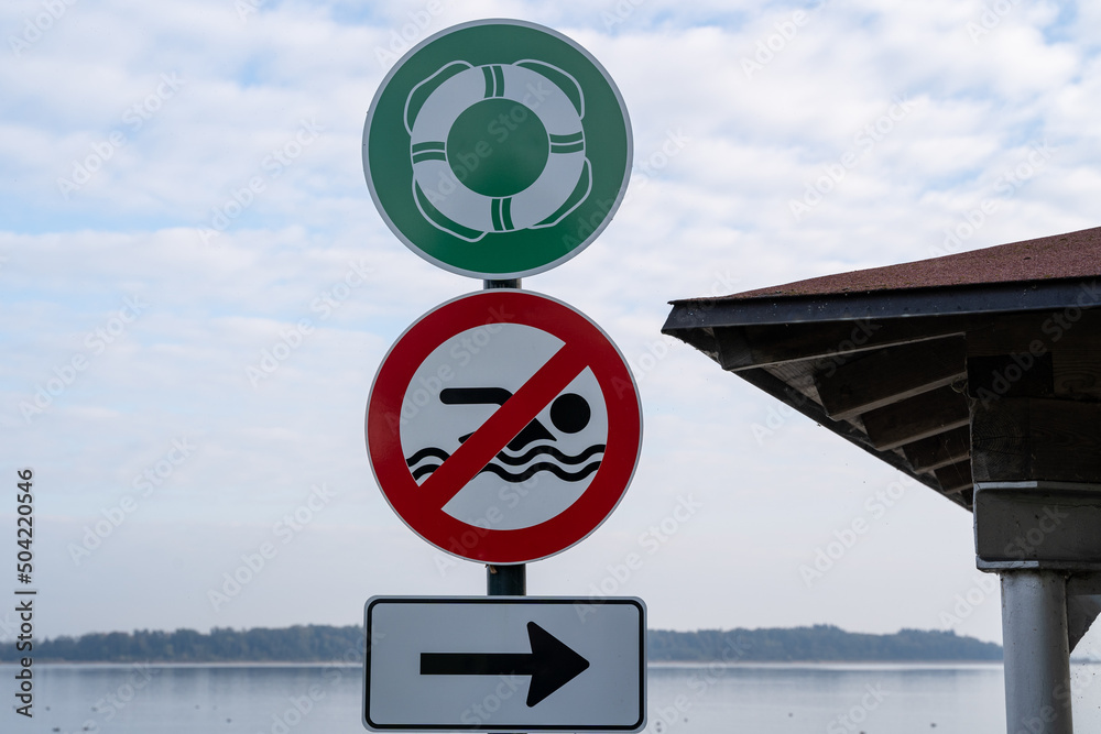 Green sign with a swimming ring, red sign with a crossed out swimmer ...