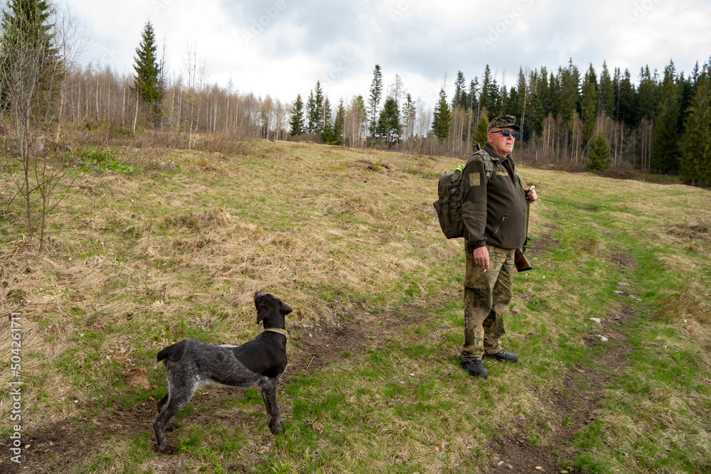 Old Hunter in the woods with his dog. Male hunter hunting with his ...