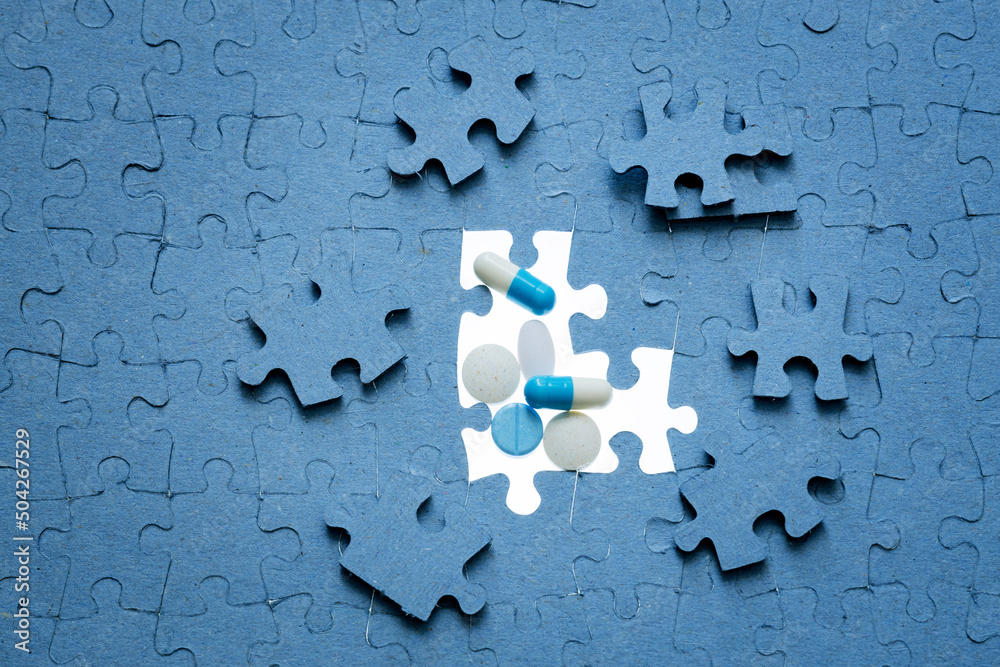 pills and medicine in capsules on the missing puzzle piece, concept of ...