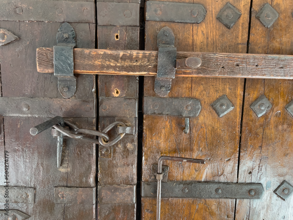 The medieval closing locking mechanism on very old wooden door. Wood ...