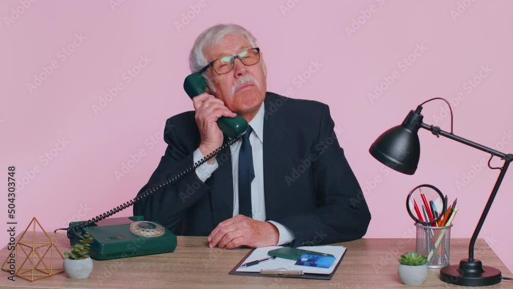 Crazy senior businessman talking on wired vintage telephone of 80s ...