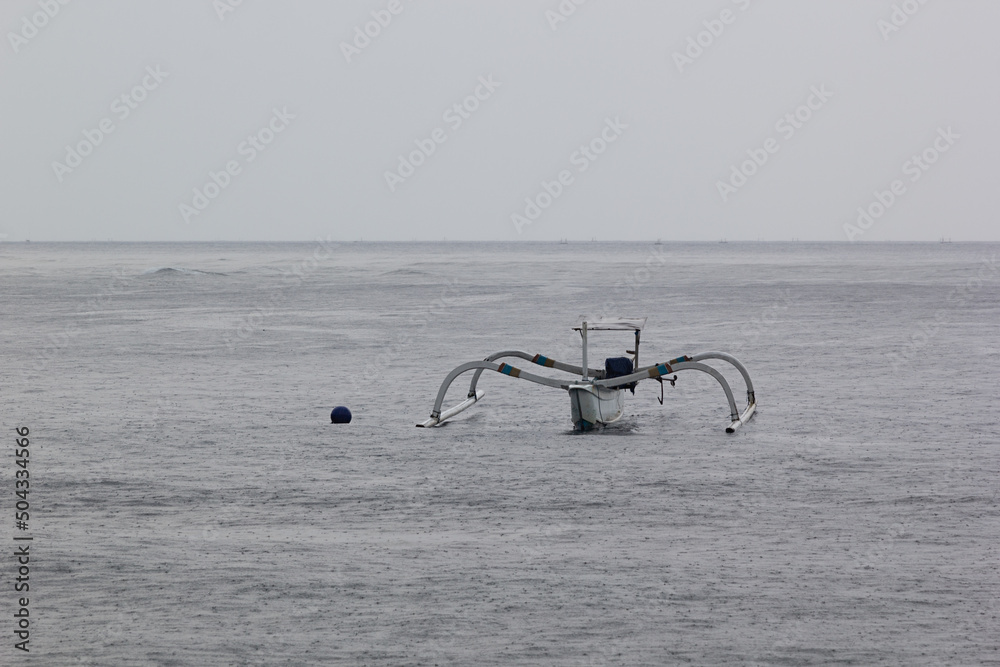 Sea landscape with storm - indonesian traditional fishing boat float in ...