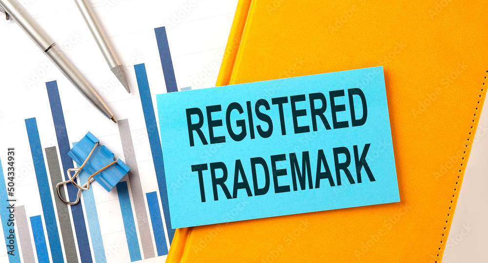Registered trademark text on sticker on the yellow notebook with chart ...