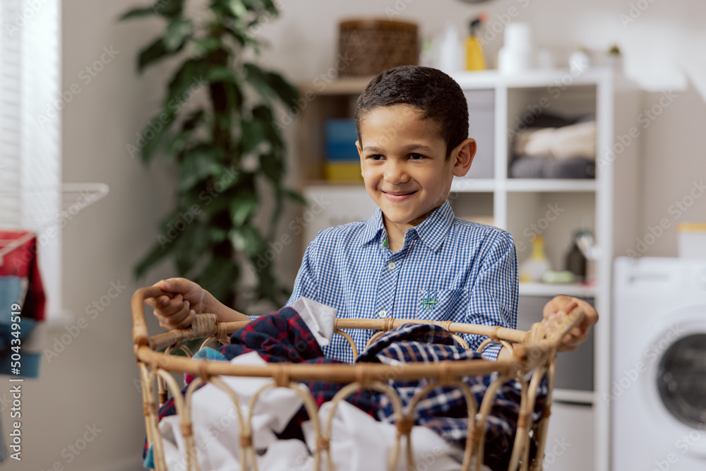 Smiling handsome little boy stands in the middle of the bathroom ...
