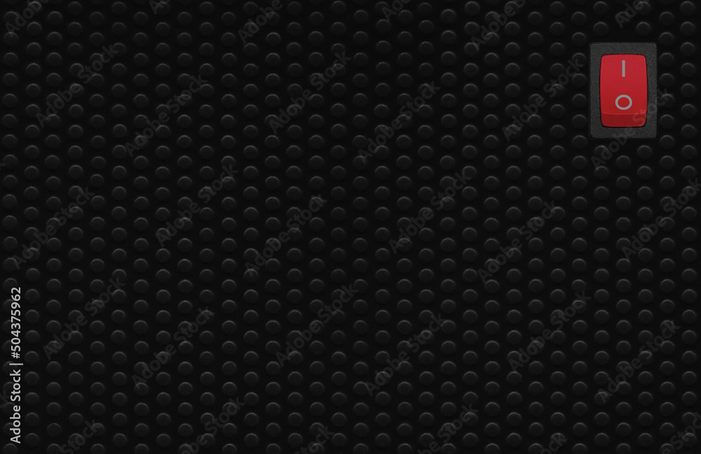 Red rectangle rocker power switch in on position, black abstract dot ...