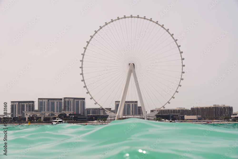 View of Ain Dubai ferris wheel and city skyline from Jumeirah Beach ...