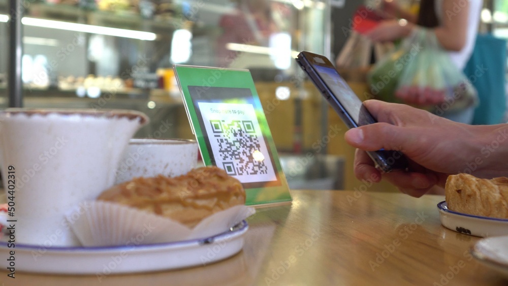 Smartphone scanning the recipients QR code. Mobile banking. Customers ...