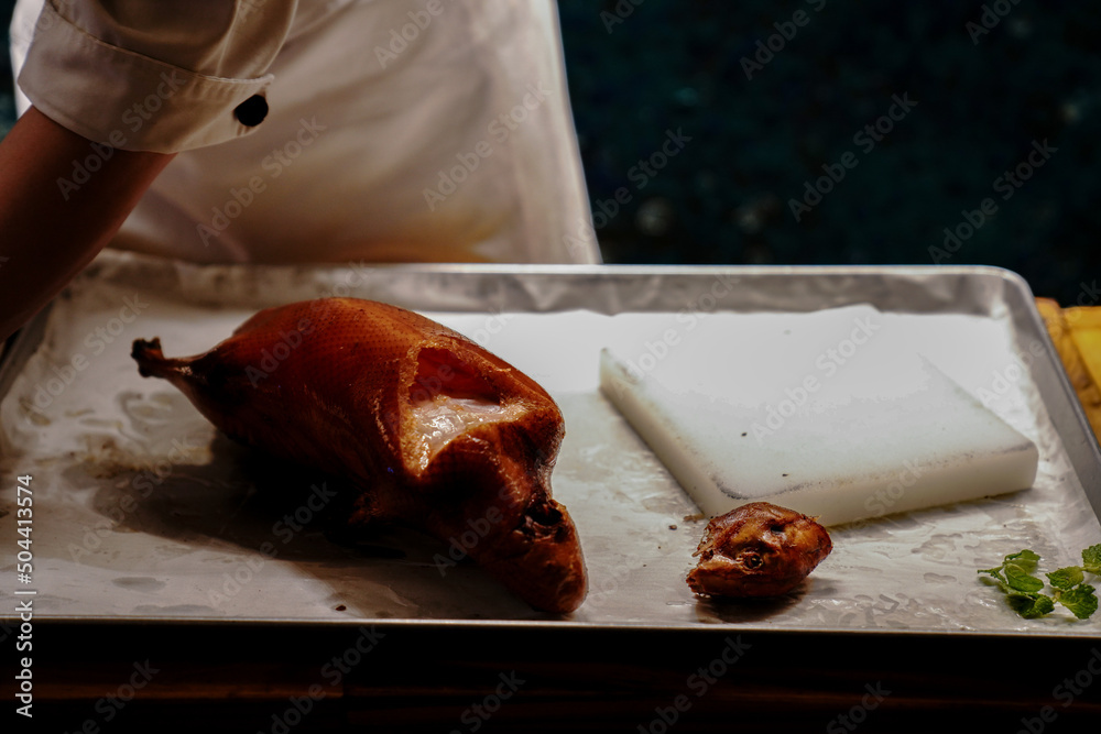 Foto de Chinese cook prepares Peking Roast Duck. Peking Duck is a ...