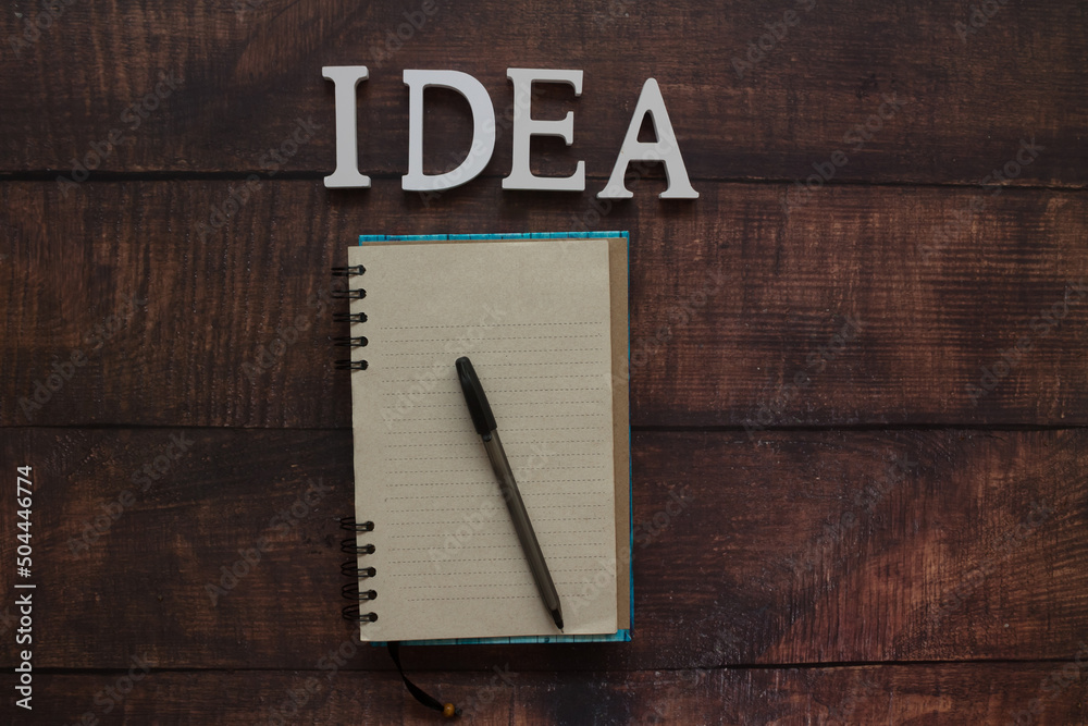 Letras de la palabra idea y libreta de papel reciclado en fondo de ...