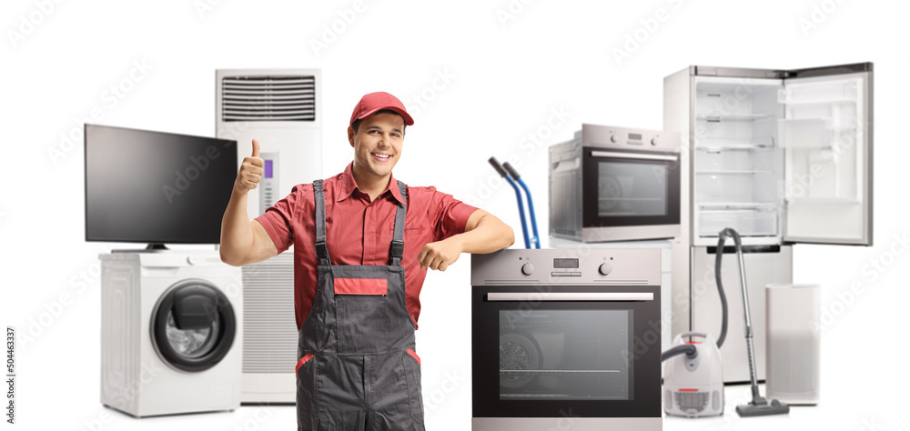 Handyman in a uniform standing next to electric appliances and giving ...